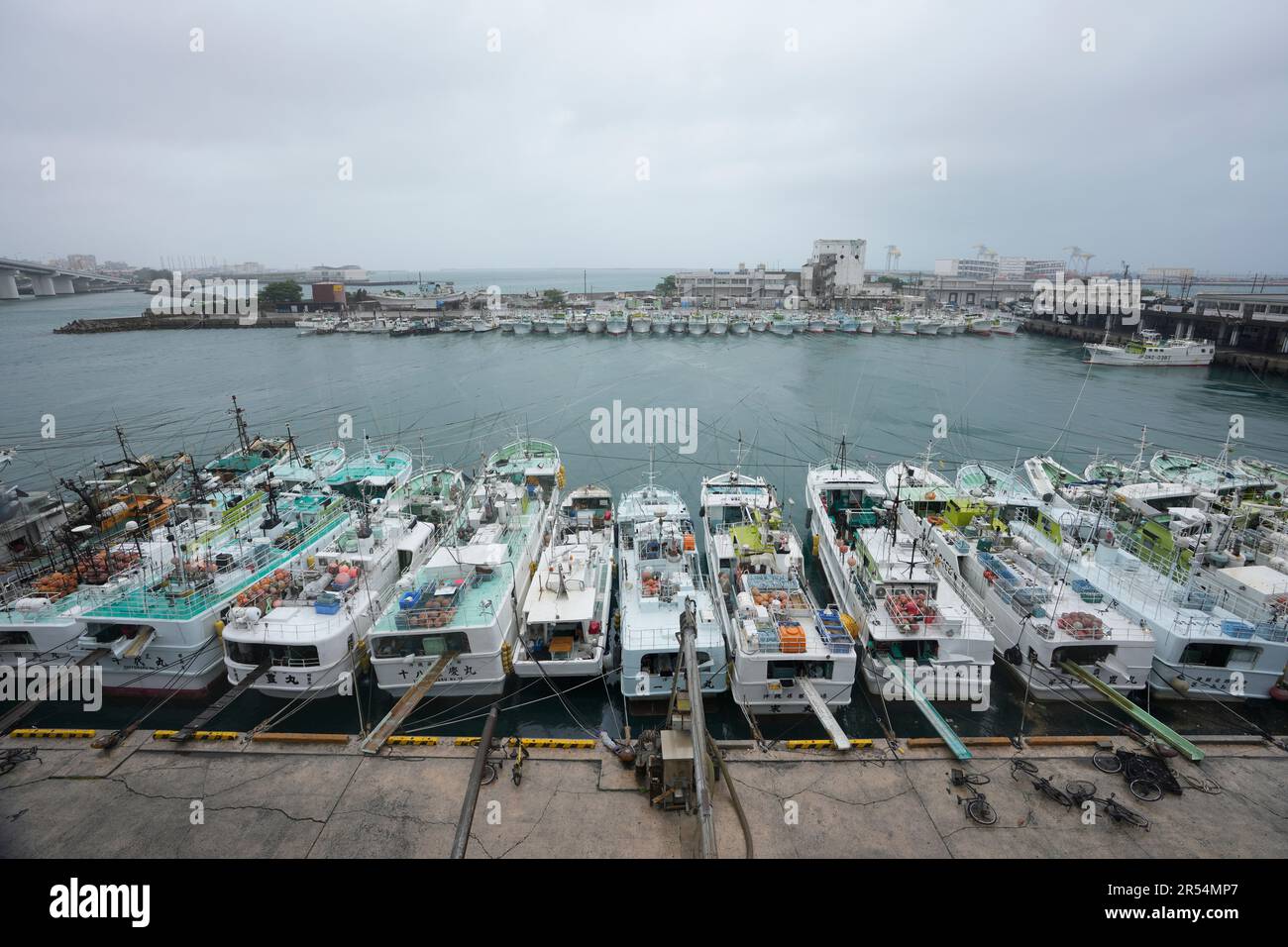 Fishing boats are secured by rope at the Tomari fishery port in Naha in ...