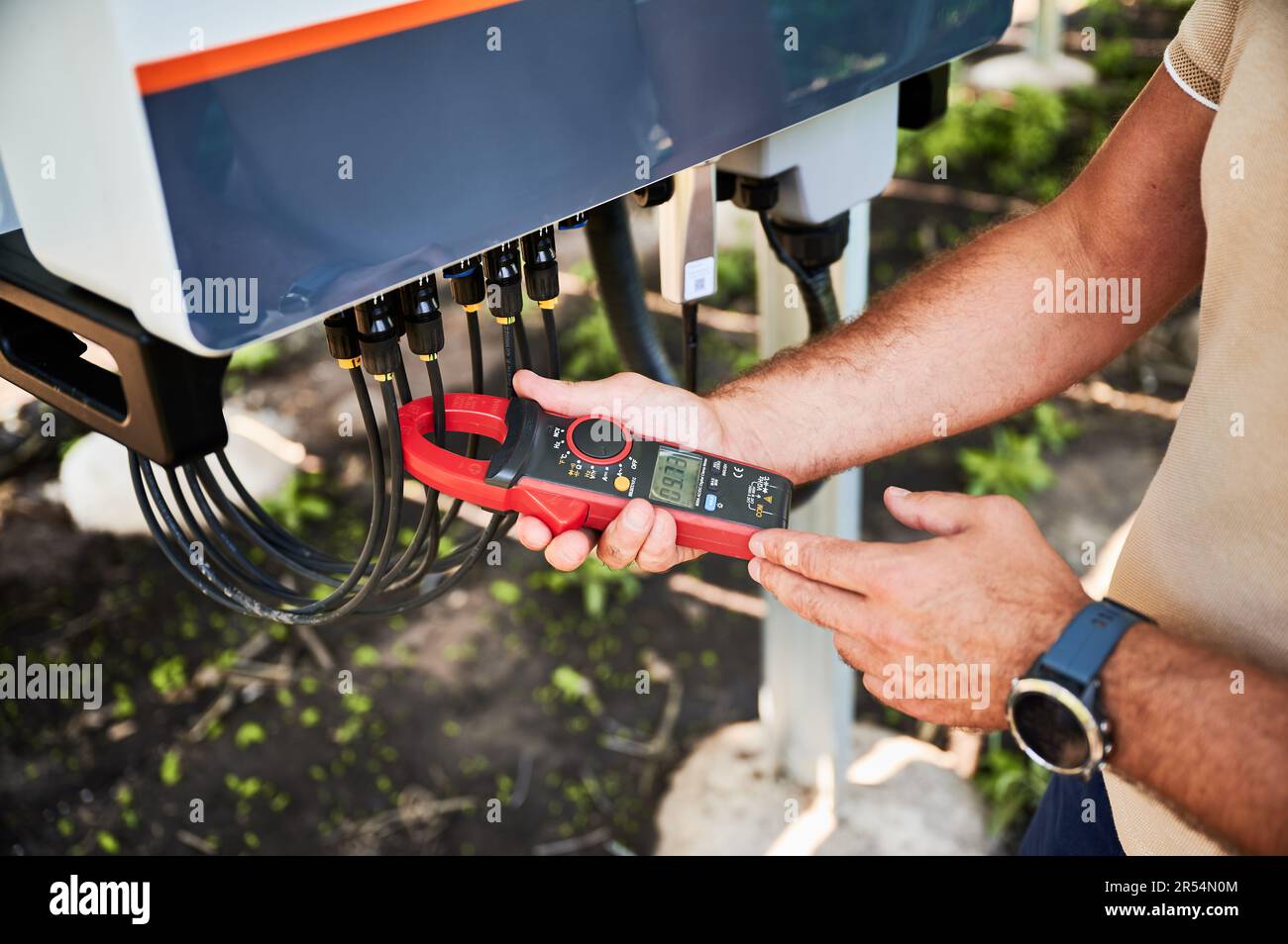 Inspector checking output voltage level of inverter. Professional ...