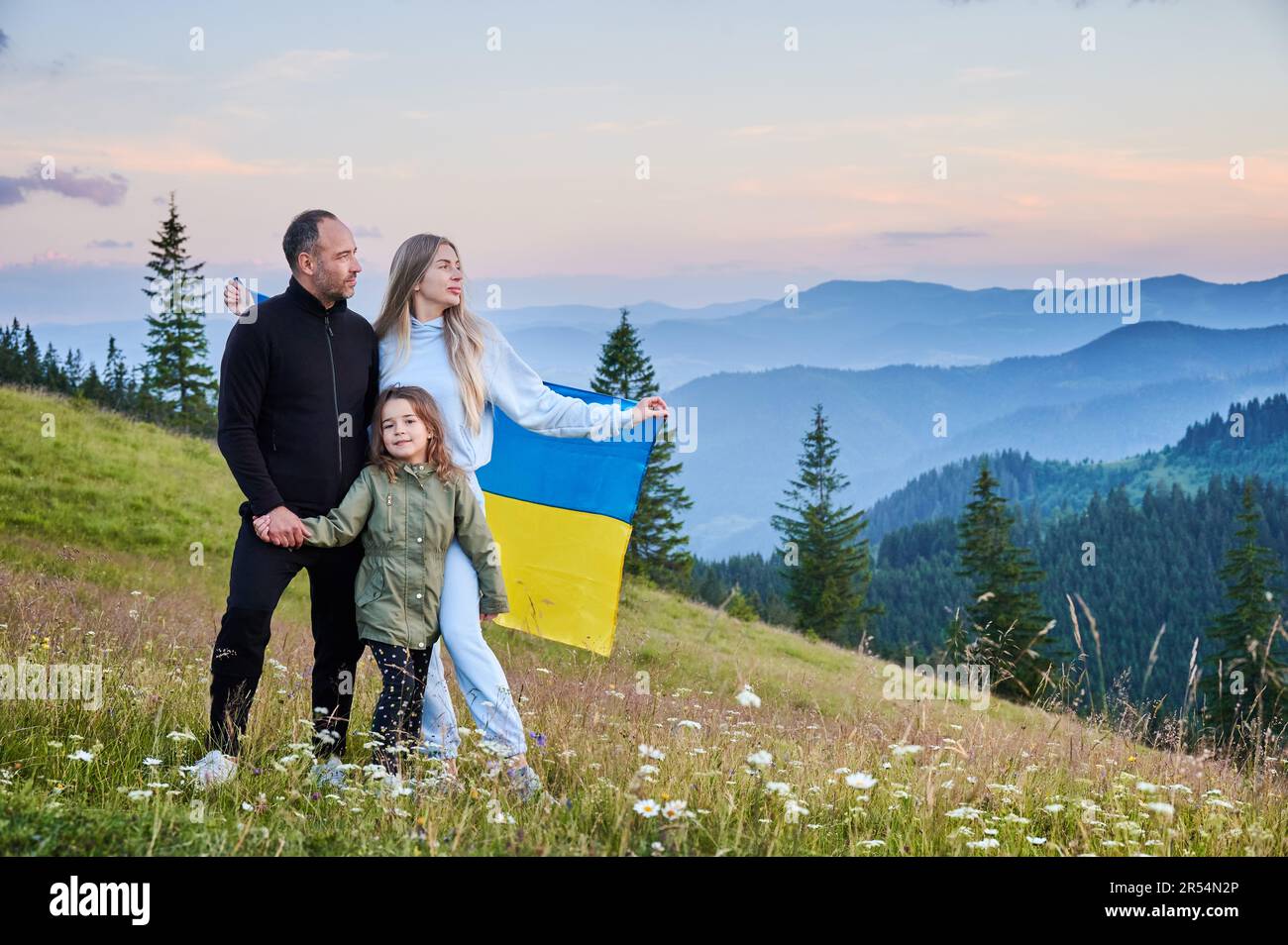 Lovely Ukrainian family resting in mountains. Male adult and his wife ...