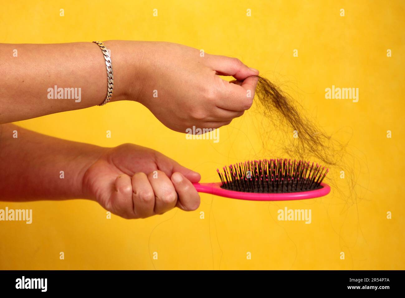 Adult Latina woman suffers from hair loss when brushing it, a symptom ...
