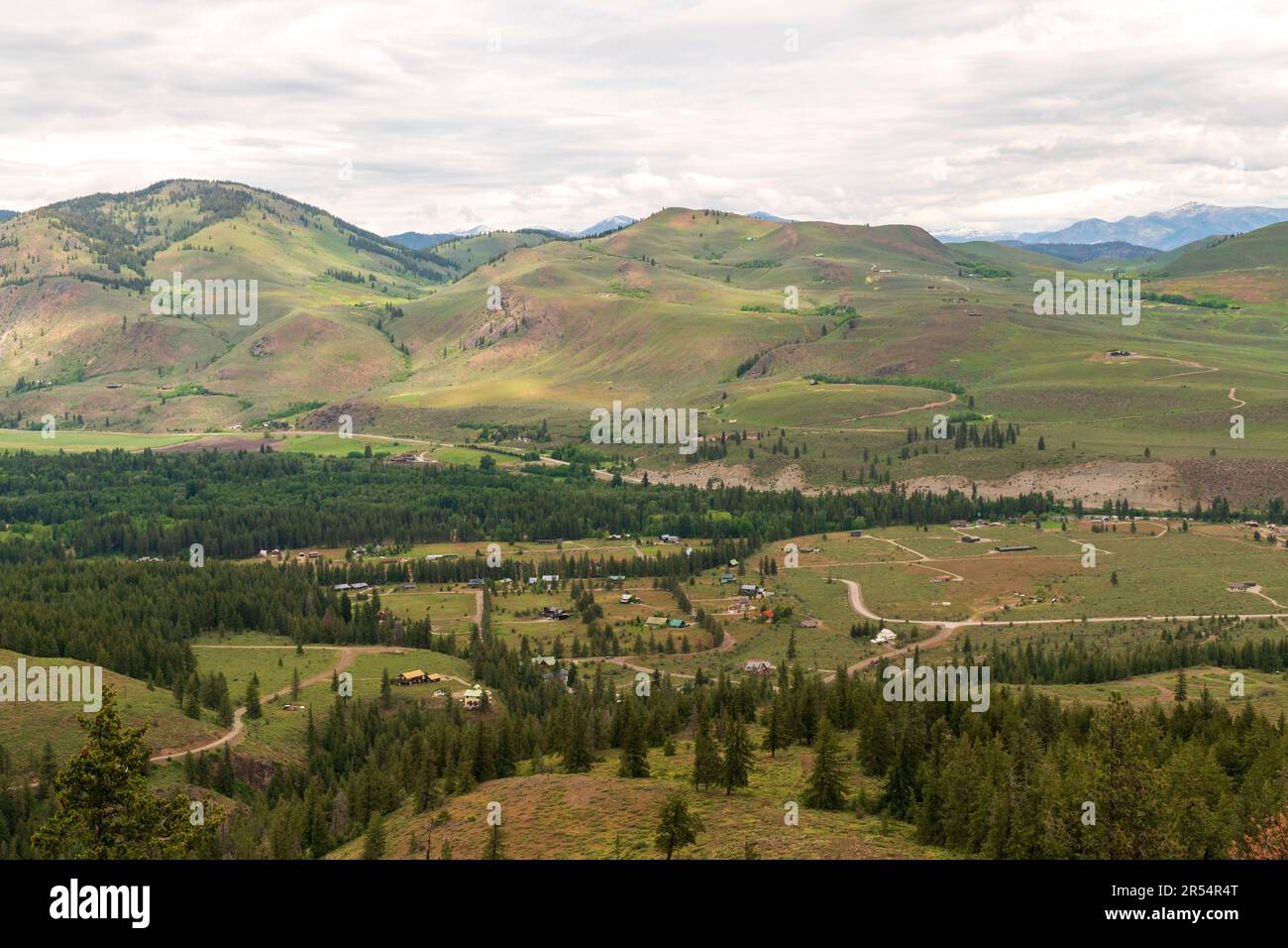 A community of houses and undeveloped lots rests at the base of the ...