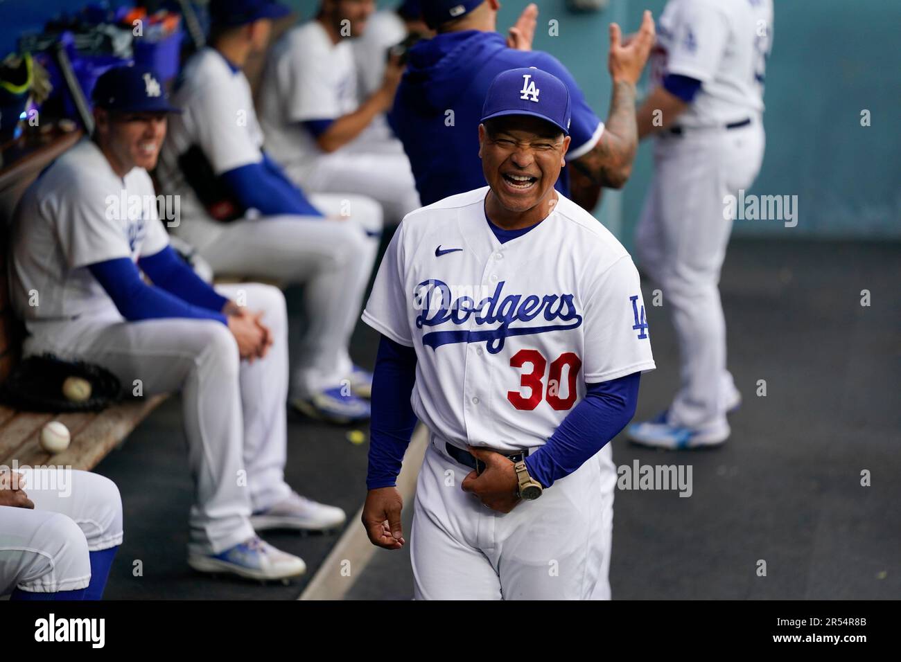 Los Angeles Dodgers manager Dave Roberts (30) laughs in the dugout ...