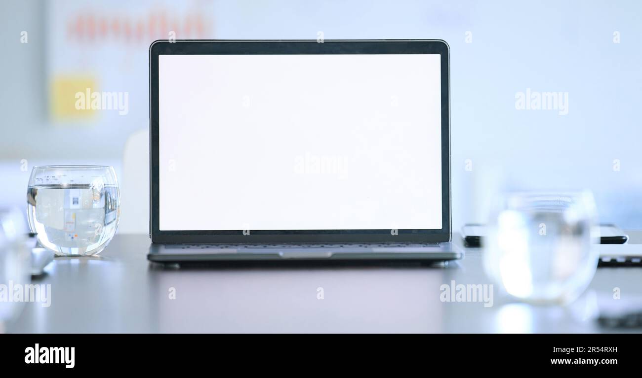 Laptop screen, mockup and boardroom of a tech company at a desk with ...
