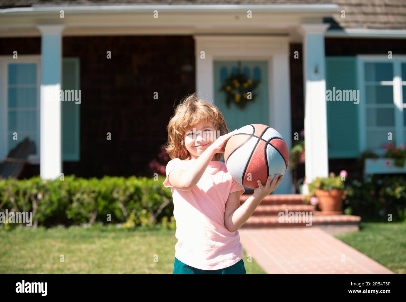 Kid playing basketball. Child posing with a basket ball outside Stock ...