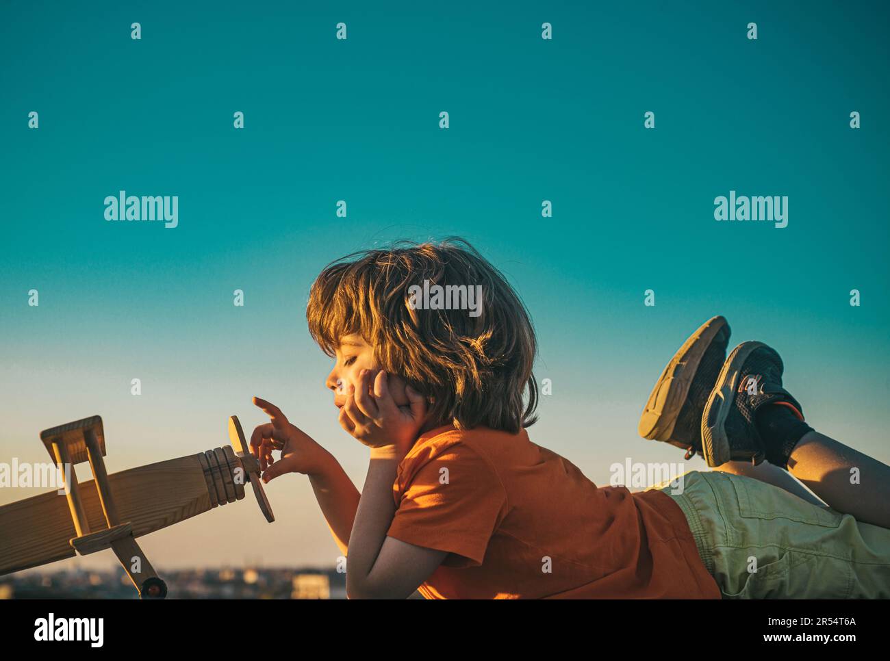 Little boy with wooden plane, boy wants to become pilot and astronaut ...