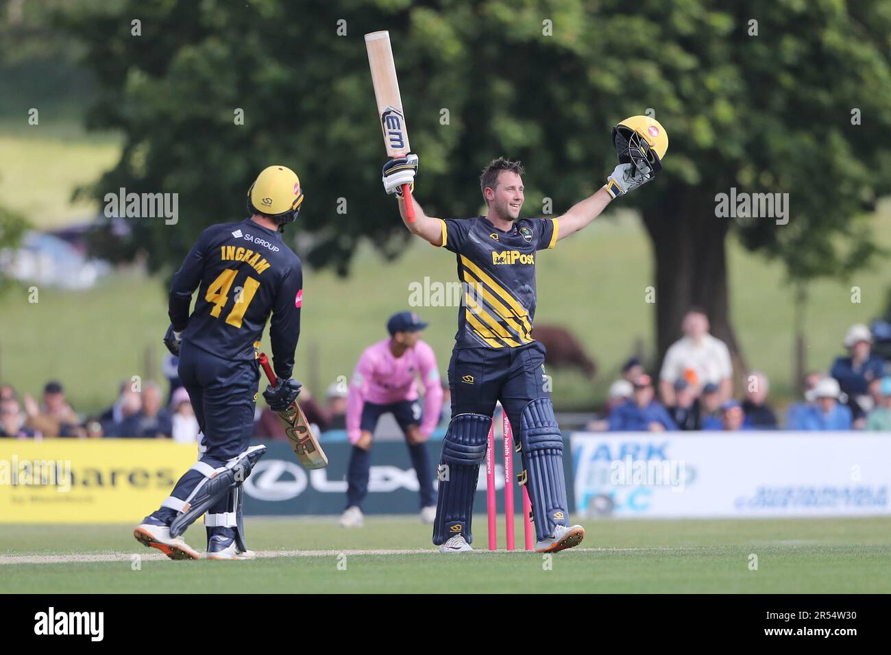 Chris Cooke of Glamorgan raises his bat after reaching his century ...