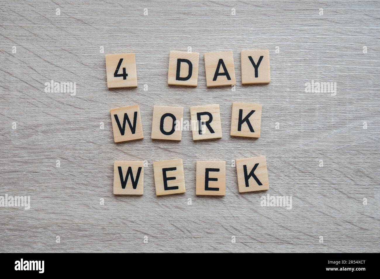 4 day work week symbol on wooden blocks four day working week concept. Modern approach doing ...