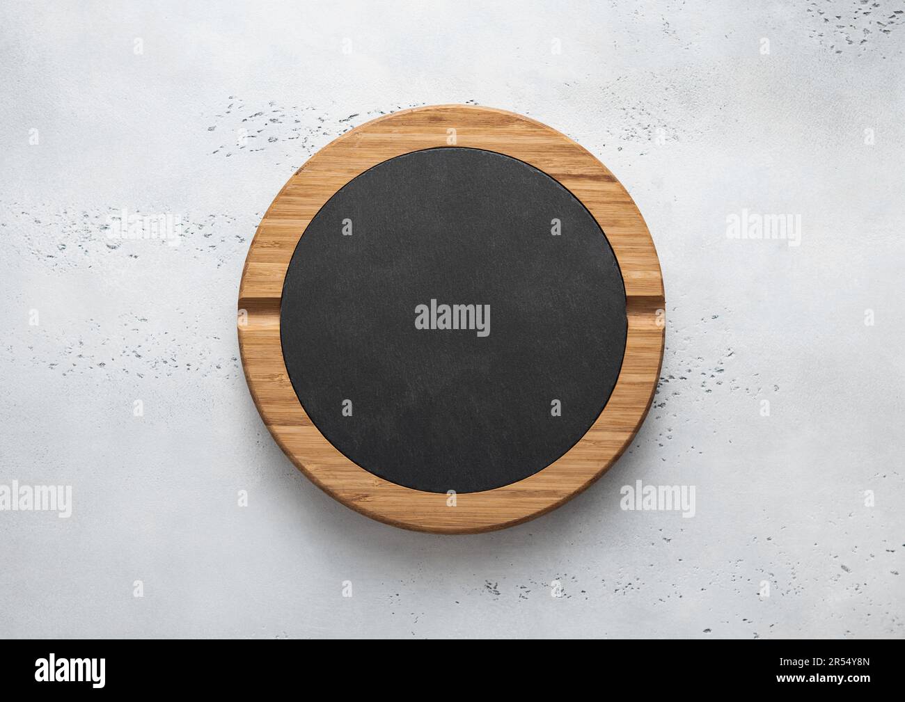 Round stone cutting board on light kitchen background.Top view Stock ...