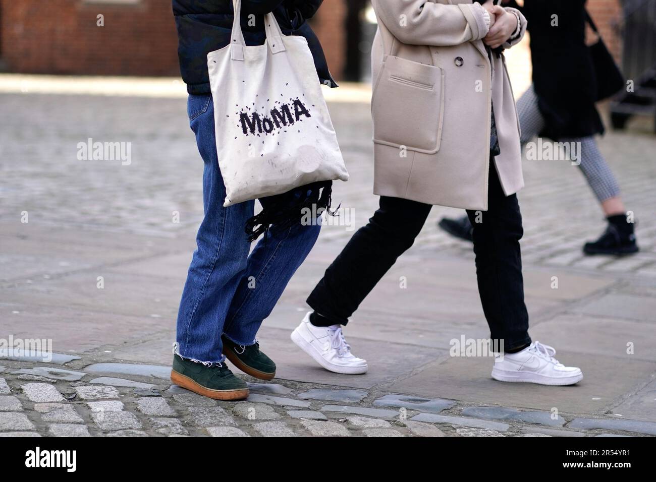 Fashion shopping. Two people carrying designer bags Stock Photo - Alamy