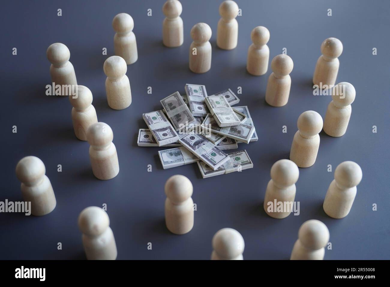 Group of wooden dolls and stack of money. Finance, donation, investor ...