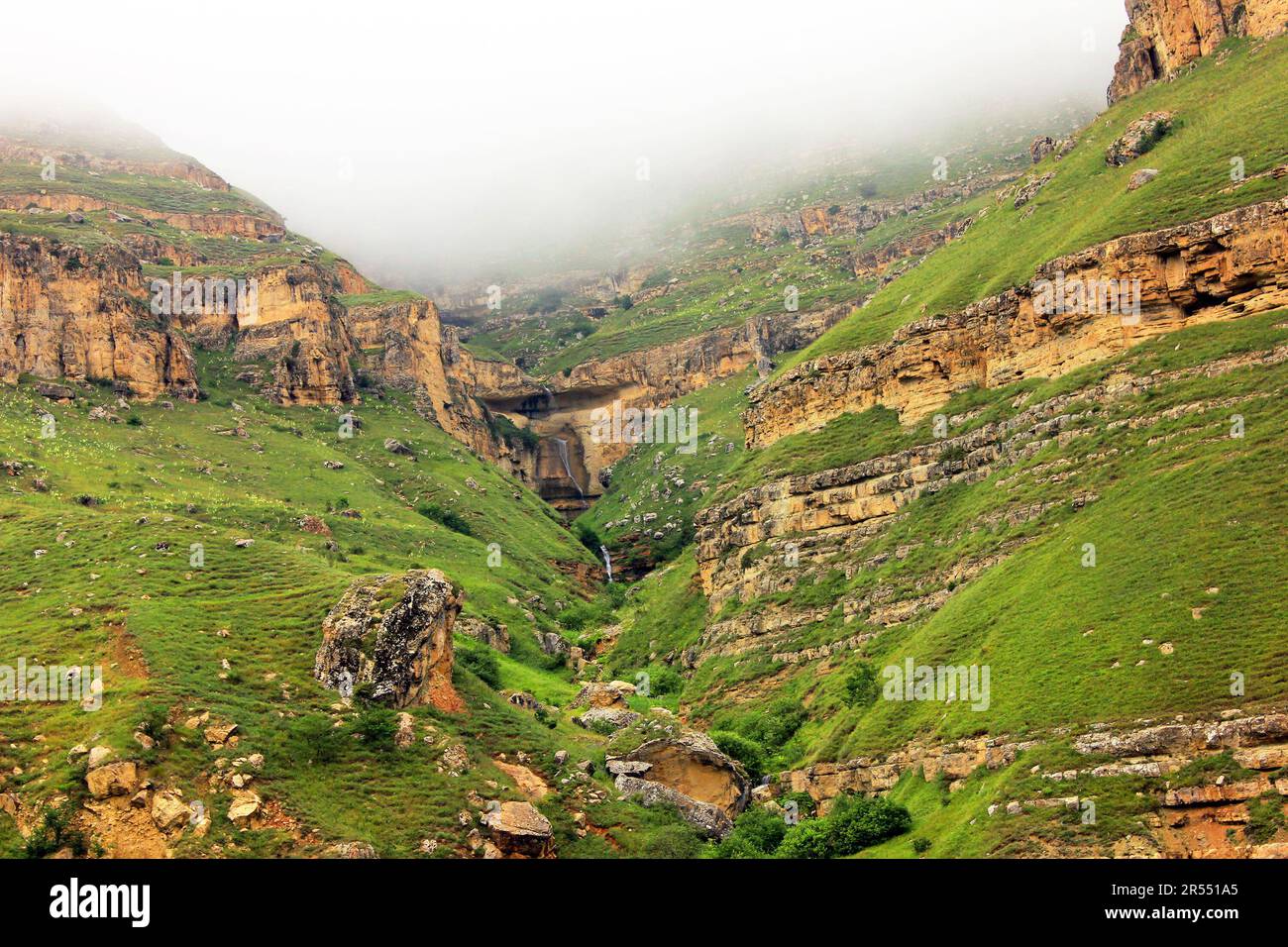 Small waterfall in the red mountains. Gryz village. Guba region ...