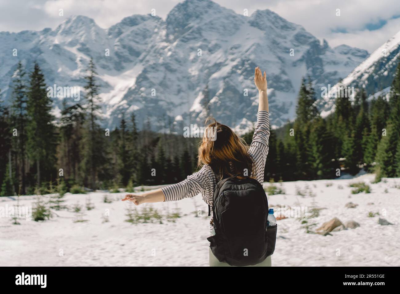 Back view of a girl traveler wearing a backpack traveling alone Stock ...