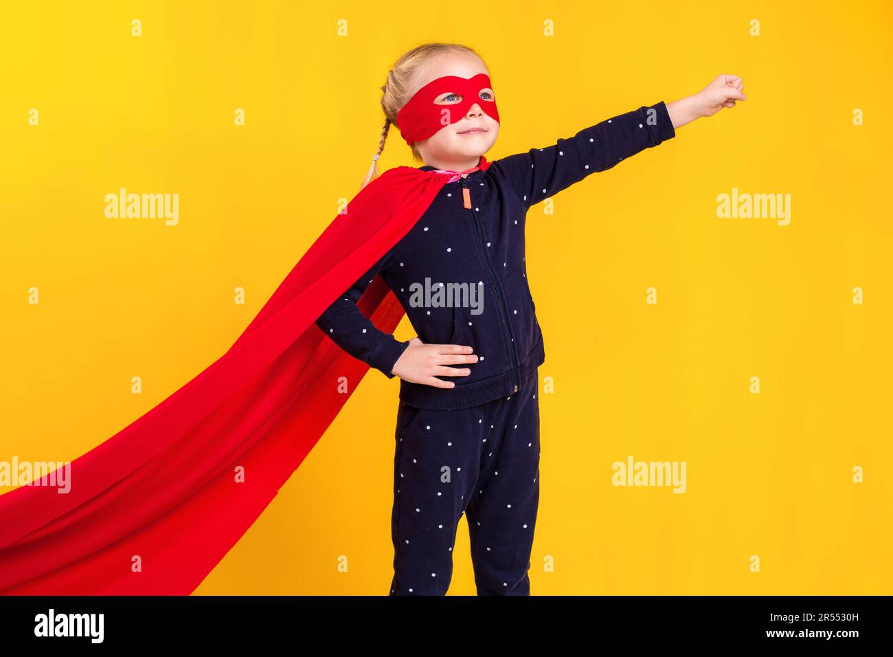 Superhero little girl in a red raincoat and a mask Stock Photo - Alamy