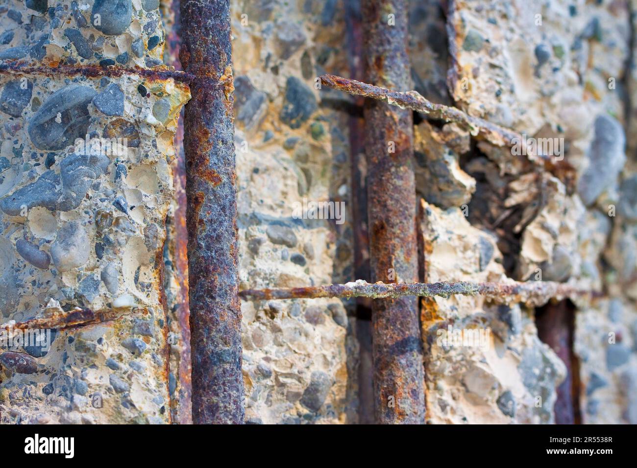 Danger cracked concrete electricity pylon with reinforcing iron bars in ...