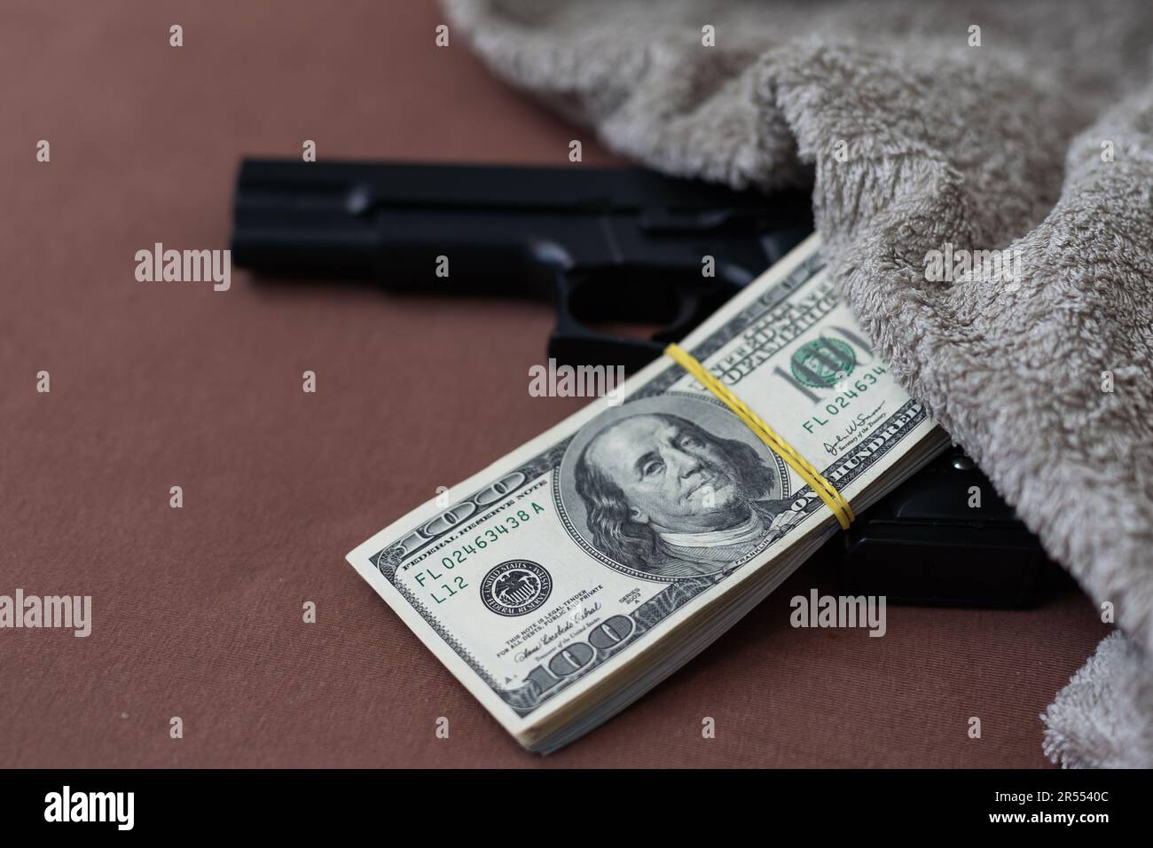 black gun on the background of cash dollars. the concept of criminal ...