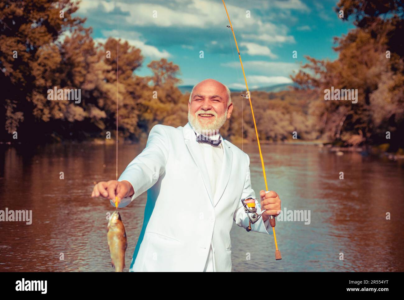 Fisherman caught a trout fish. Portrait of cheerful smiling angler ...