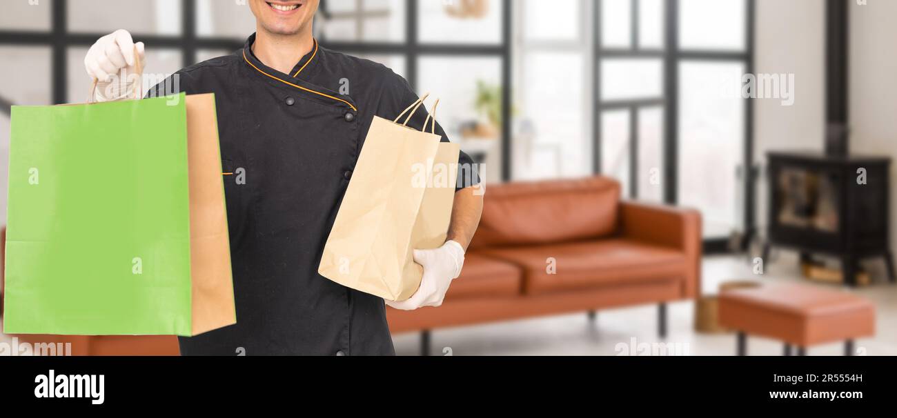 Courier holding paper bags with food, space for text. Delivery service ...
