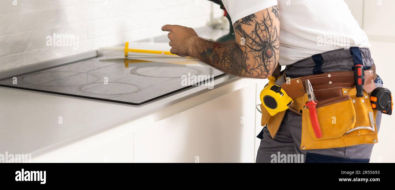 craftsman installs hob in kitchen. Household Appliance Installation ...