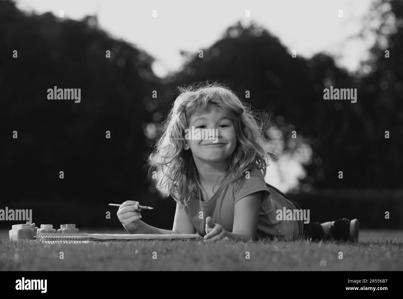 Children draw paint pictures outside, childrens creativity. Kid draws ...