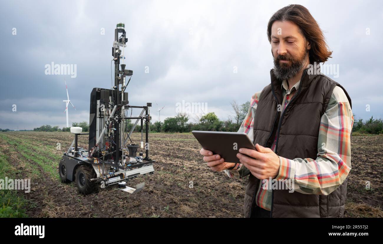 Farmer controls autonomous robot for measuring soil quality in an ...