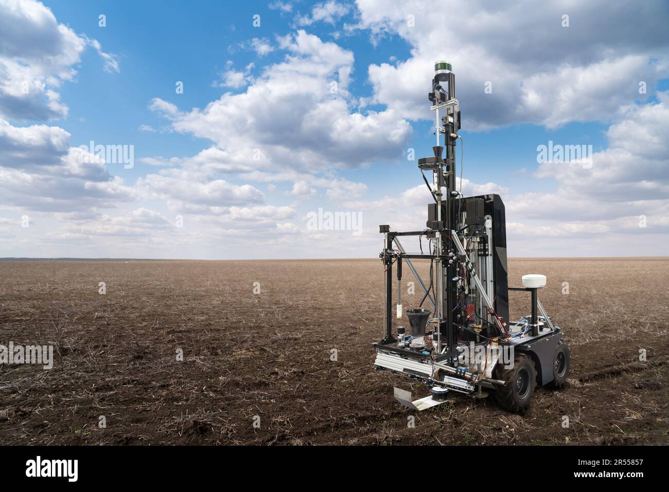 Autonomous robot for measuring soil quality in an agricultural field. Smart farming concept ...