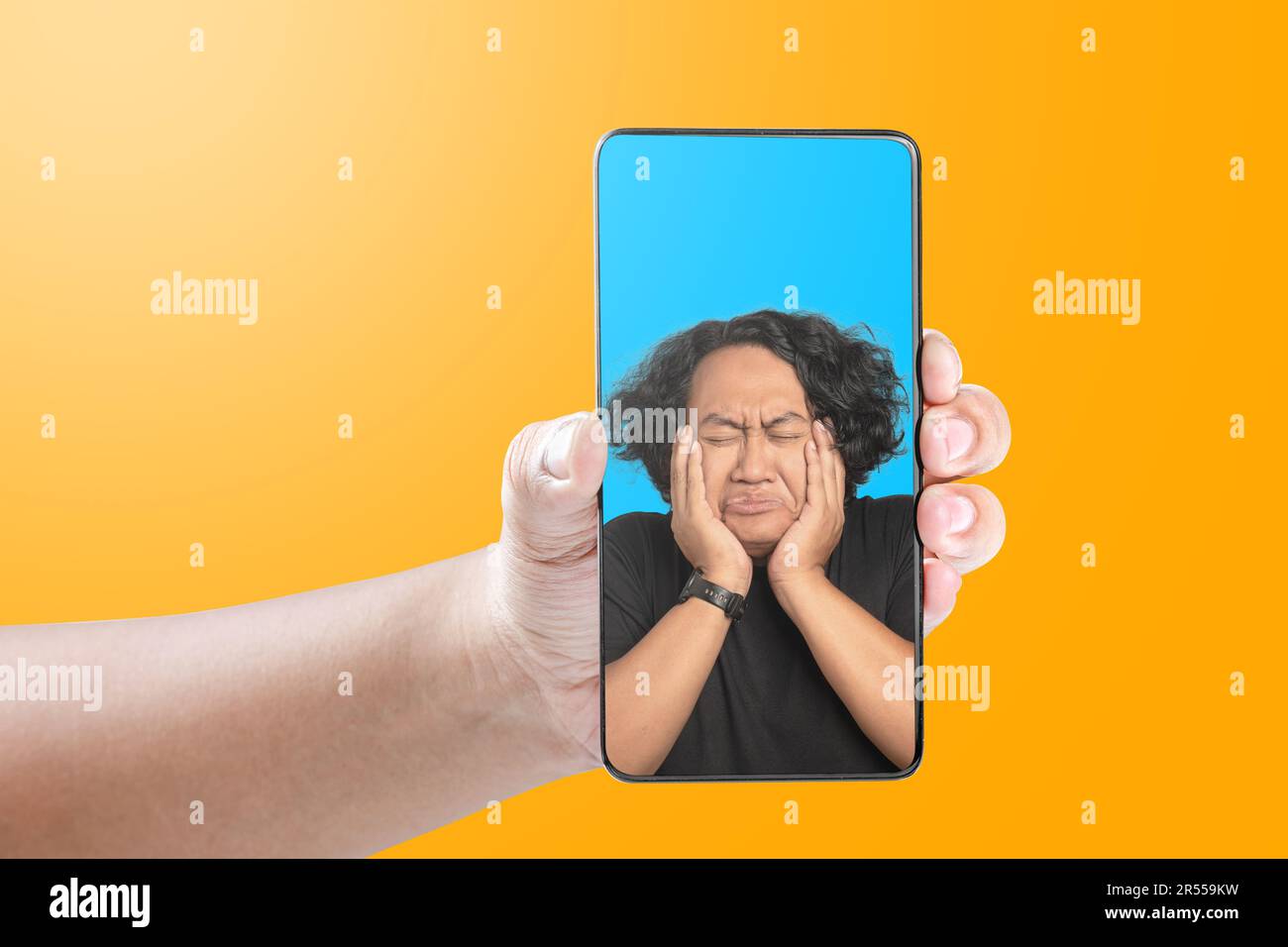 Portrait of an Asian man with a sad facial expression on the mobile ...