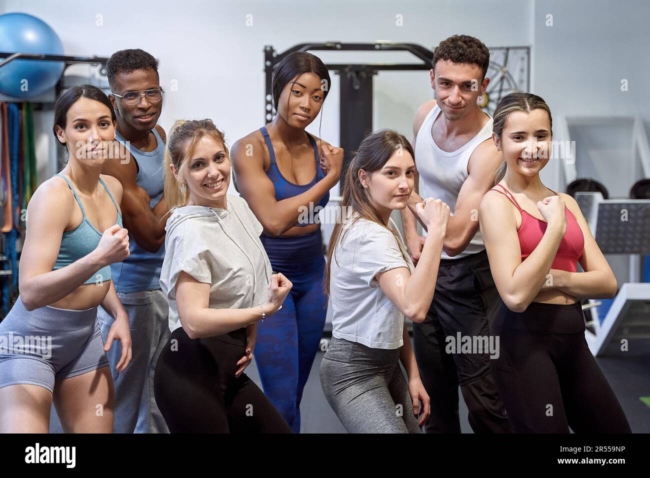 Diverse Group of Friends at the Gym, Positively Engaged, Flexing ...