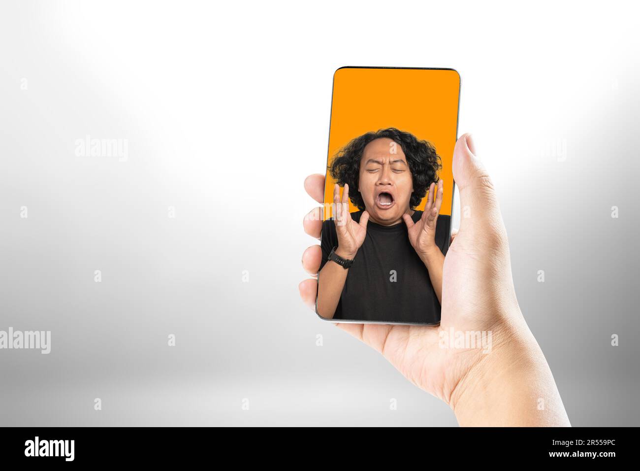 Portrait of an Asian man with a sad facial expression on the mobile ...