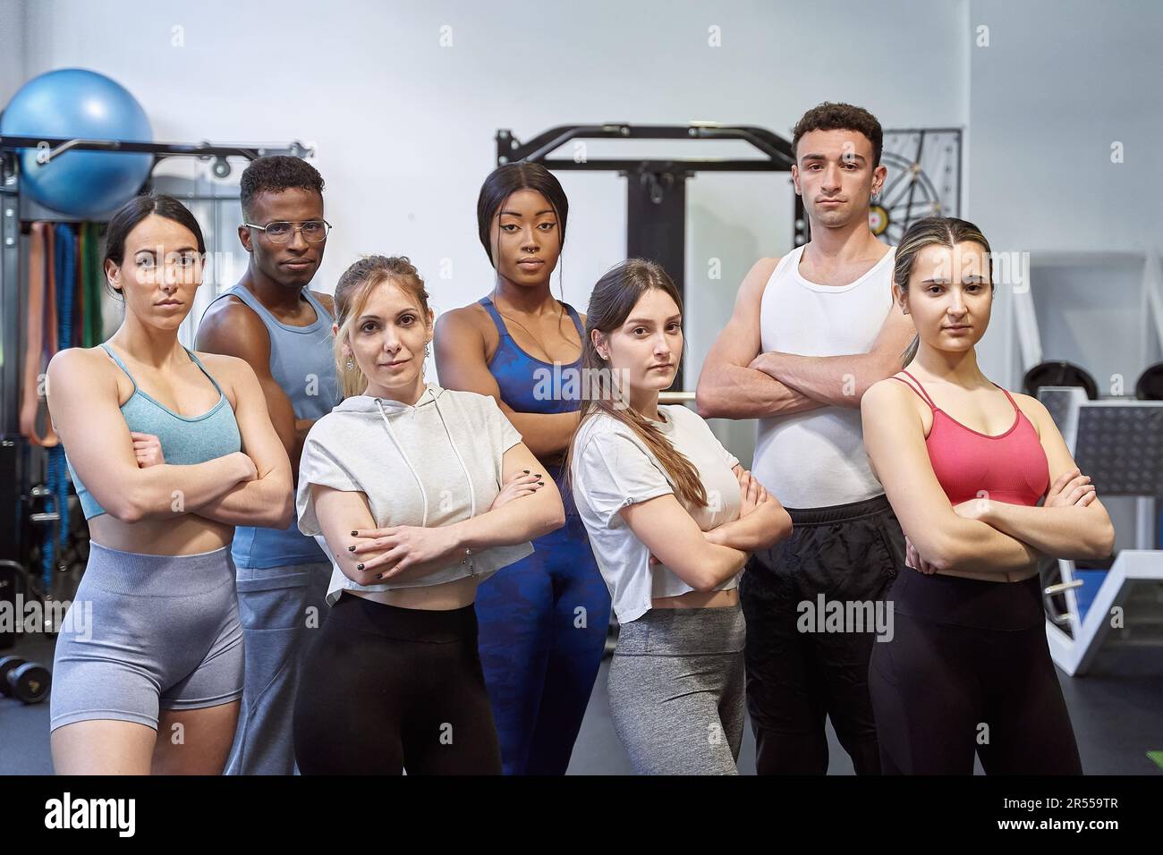 Diverse Group of Gym Friends Displaying Muscles and Intensely Gazing at ...