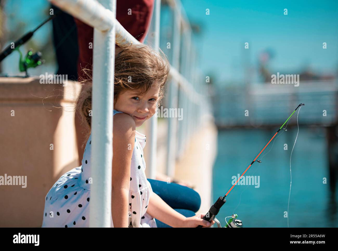Child girl fishing catches fish with fishing rod in summer Stock Photo ...
