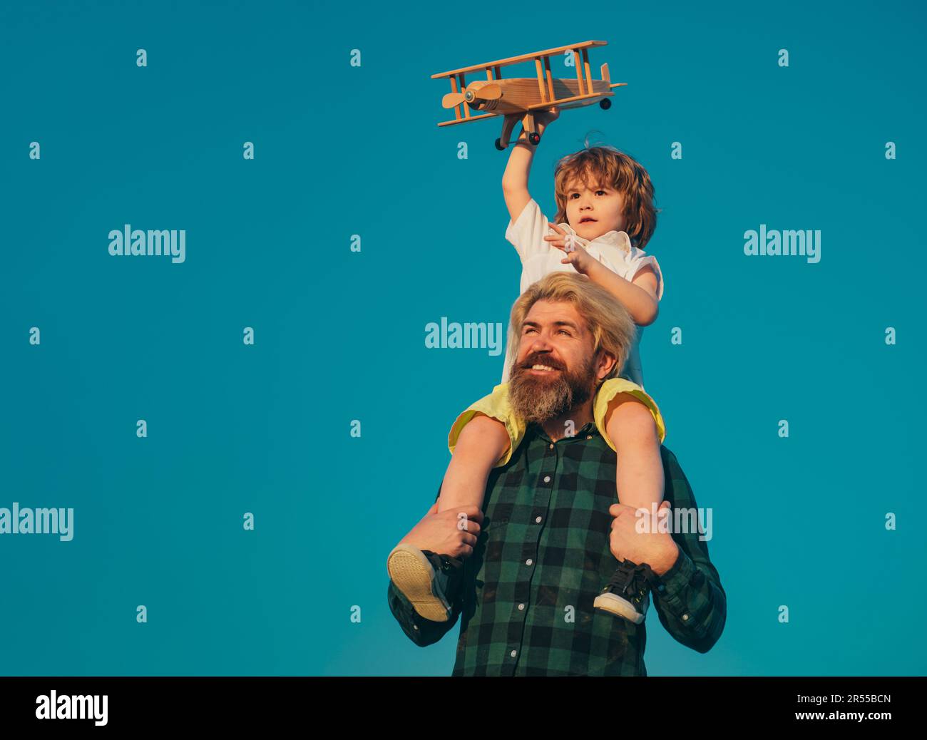 Happy father giving shoulder ride on his shoulders. Father and son ...