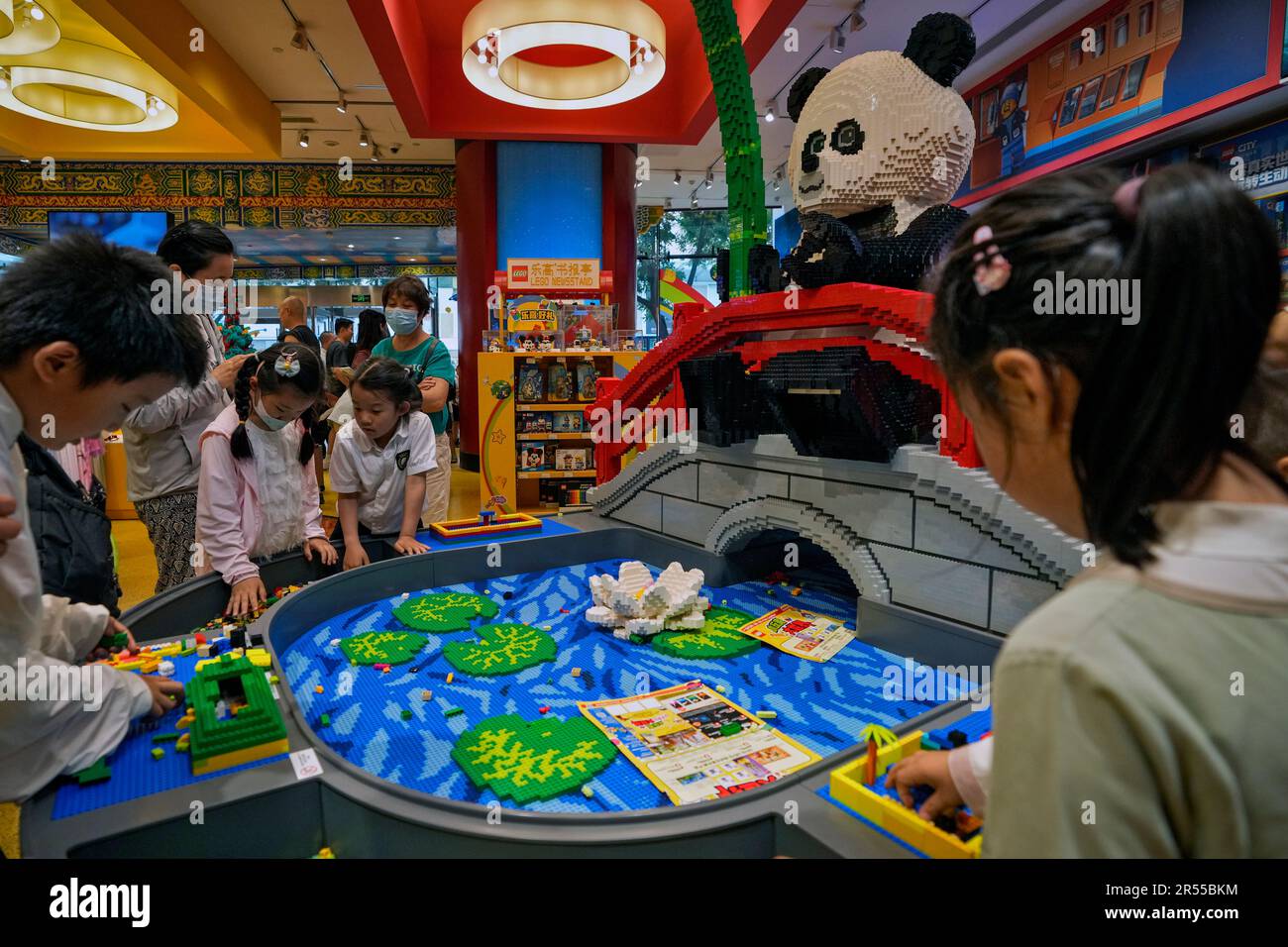 People bring their children to play Lego blocks at a retail shop on ...