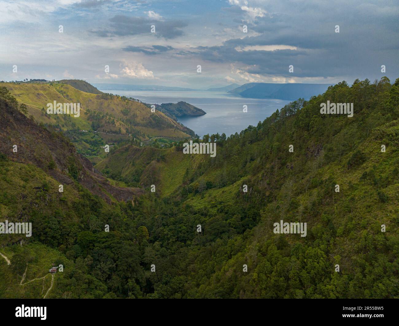 Lake Toba among the mountains with tropical vegetation. Sumatra ...