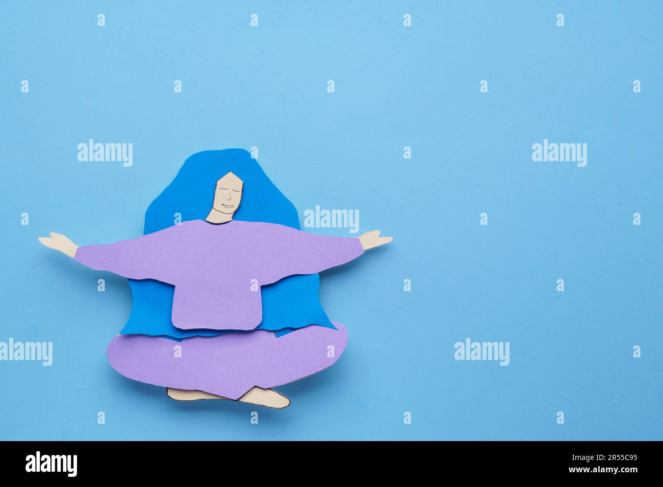 Woman paper figure on light blue background, top view. Space for text ...