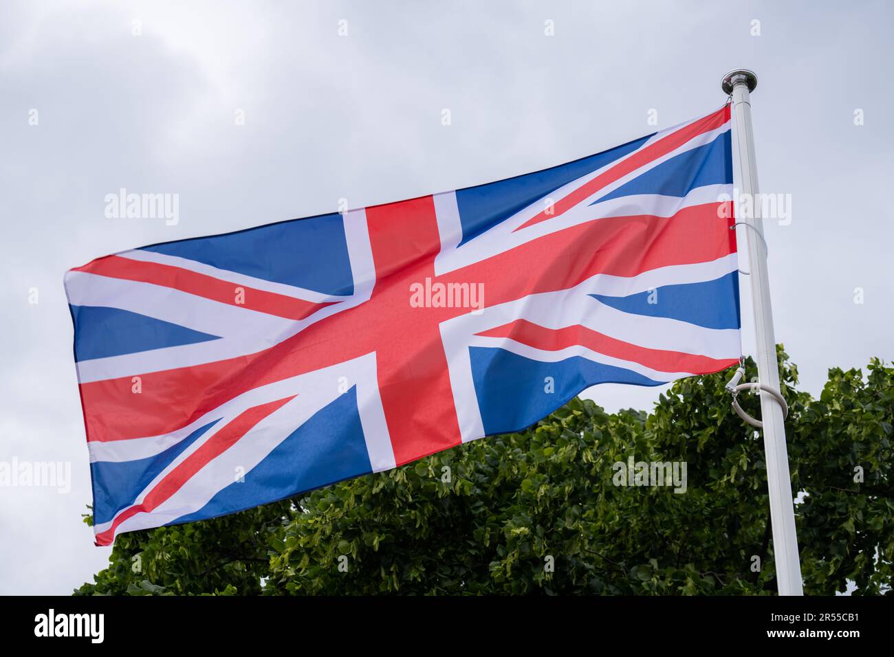 British flag flutters in the wind. State symbol of United Kingdom. High ...