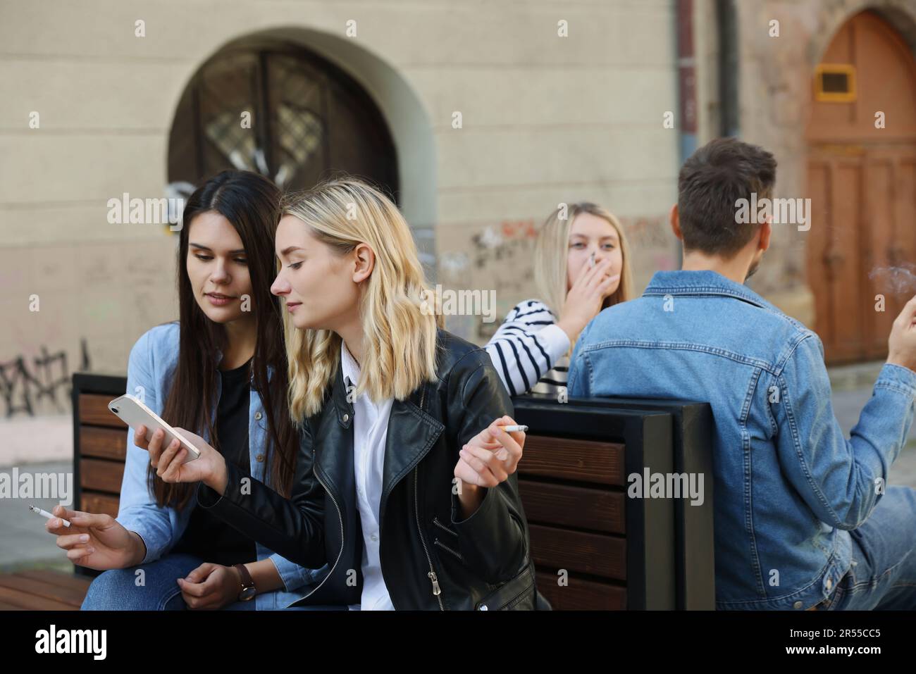 People smoking cigarettes at public place outdoors Stock Photo - Alamy