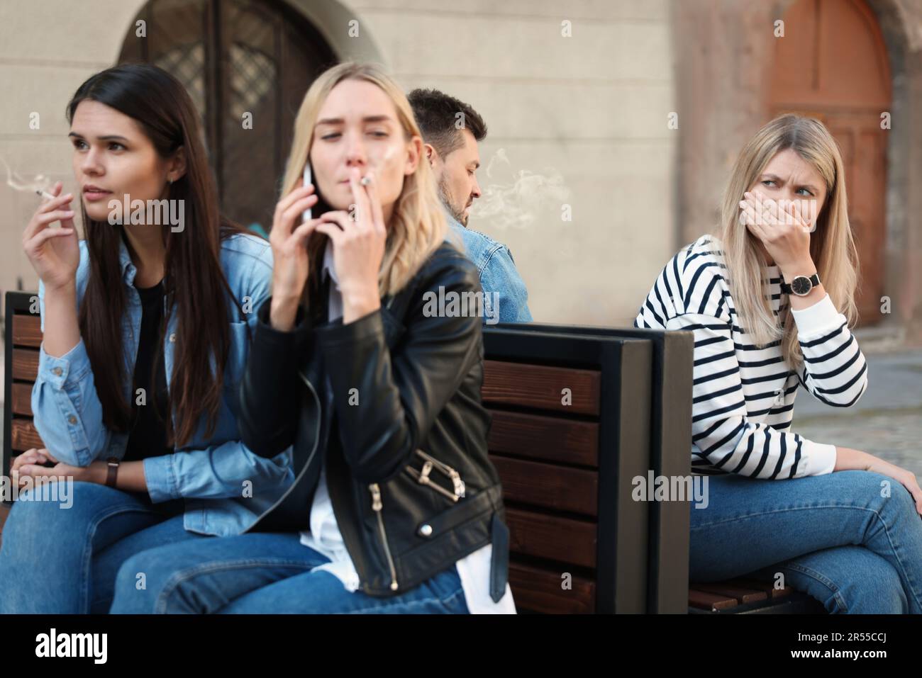People smoking cigarettes at public place outdoors Stock Photo - Alamy