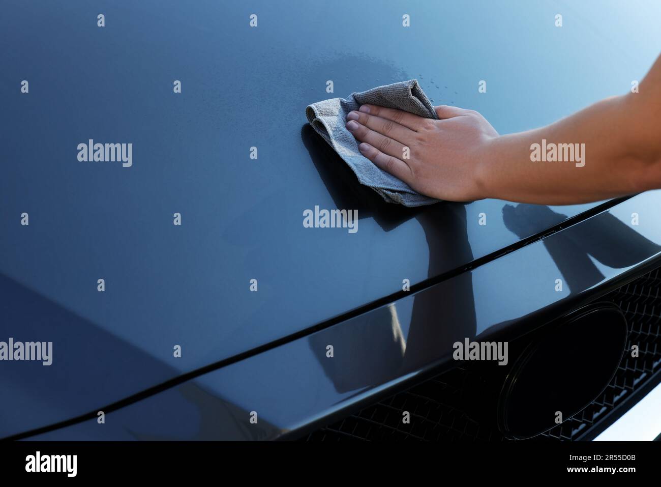Man cleaning car hood with rag, closeup Stock Photo - Alamy