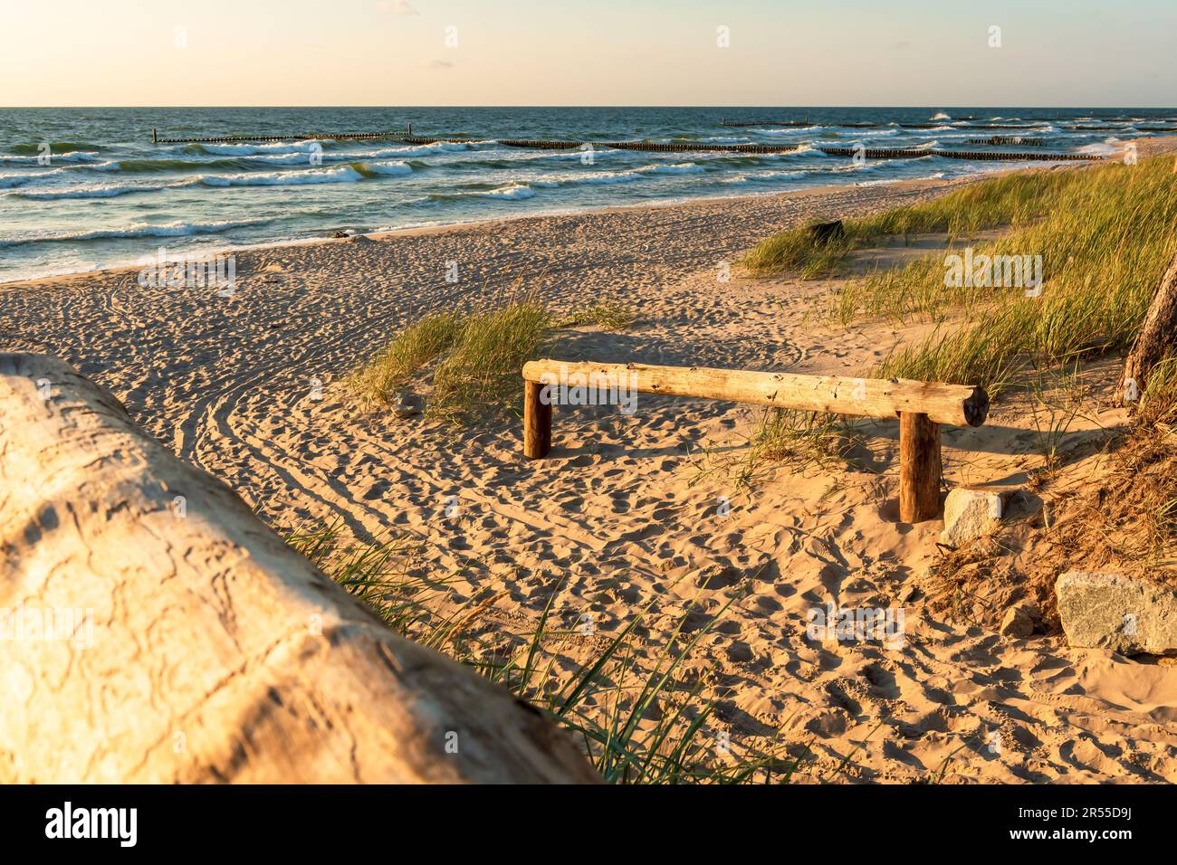 Entrance to a beautiful beach on the Baltic Sea at sunset. Wooden ...