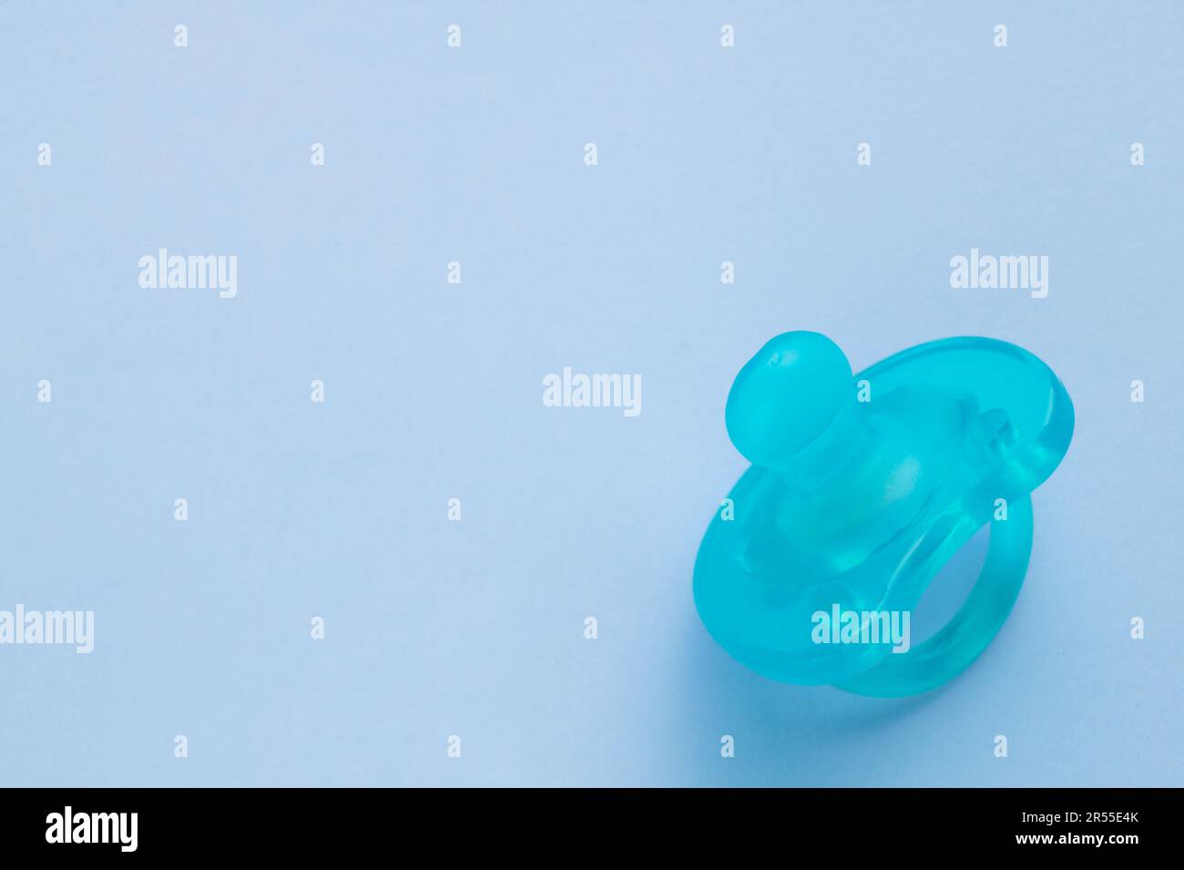 One new baby pacifier on light blue background, top view. Space for ...
