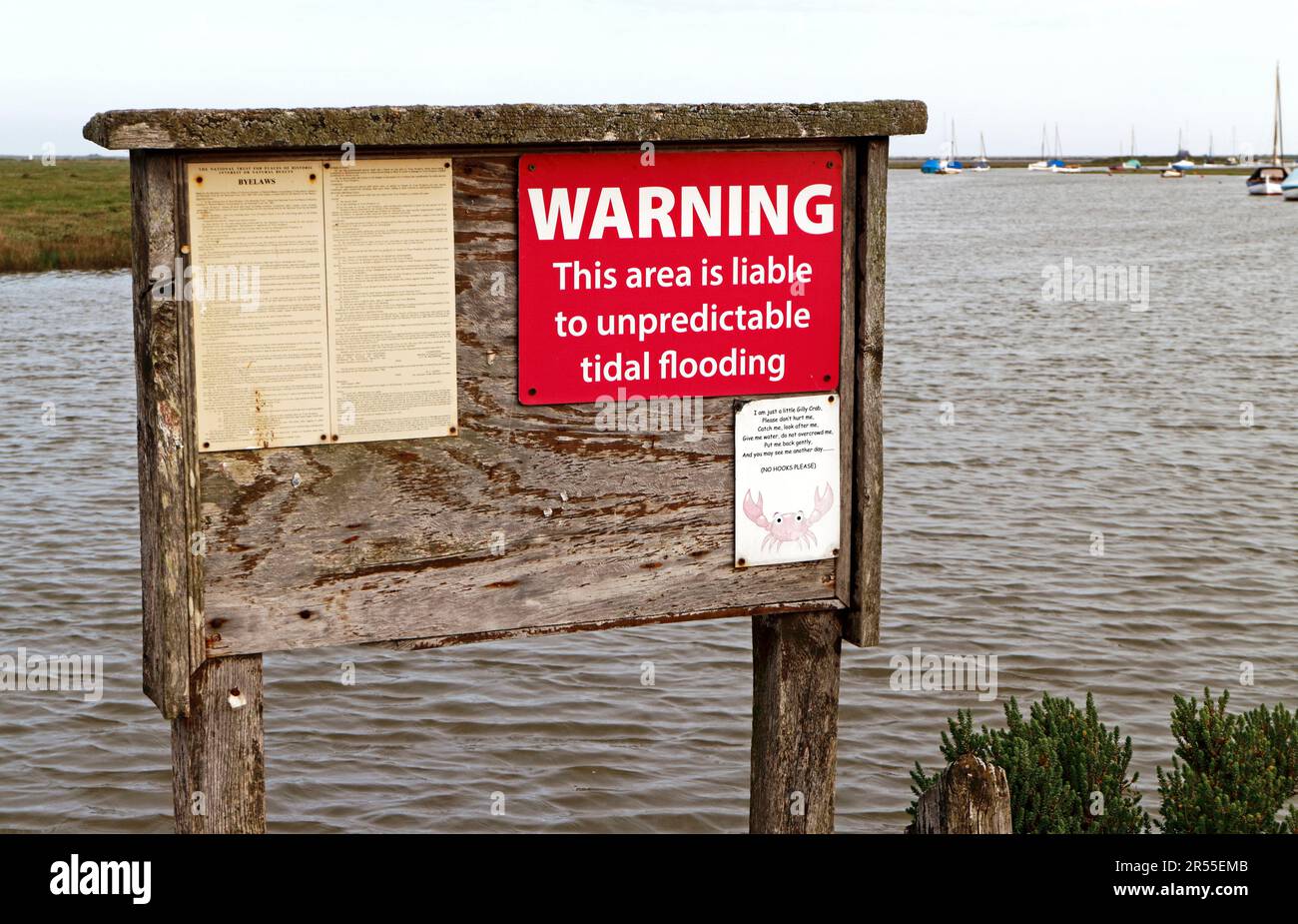 A warning sign for unpredictable tidal flooding by the quayside in the ...