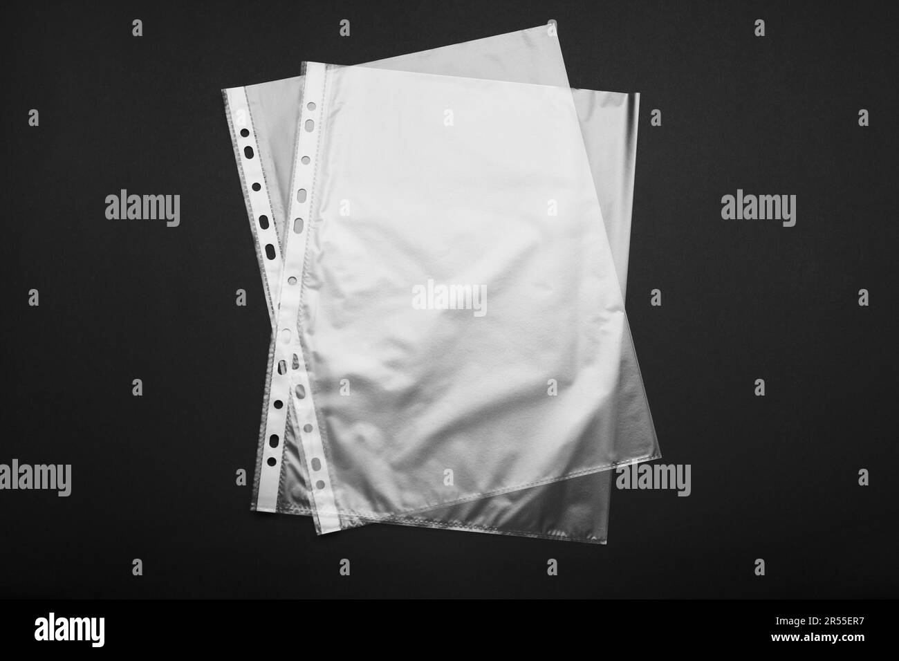 Punched pockets on black background, flat lay Stock Photo - Alamy