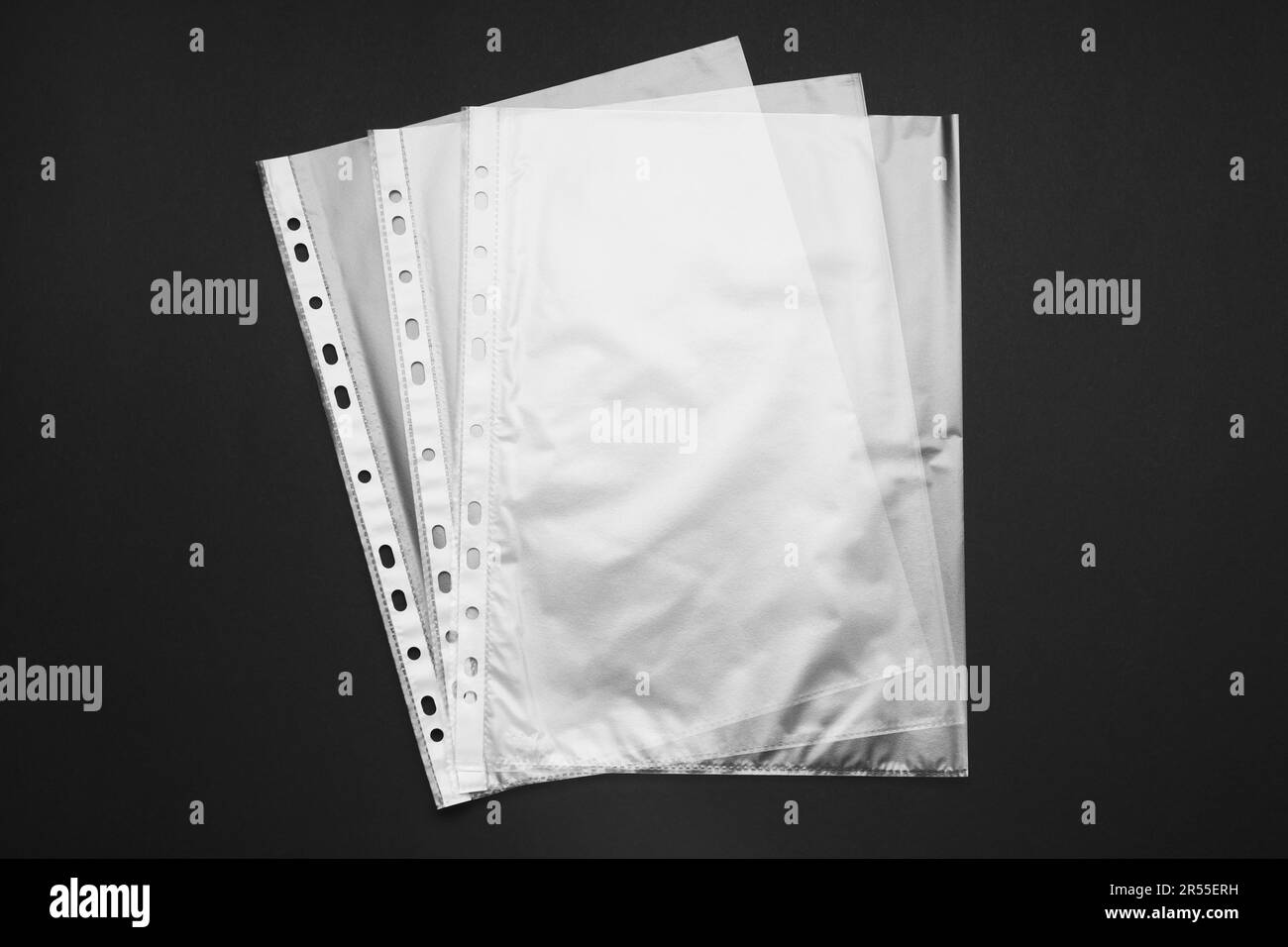Punched pockets on black background, flat lay Stock Photo - Alamy