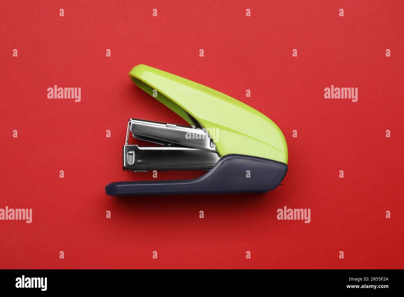 New bright stapler on red background, top view. School stationery Stock ...