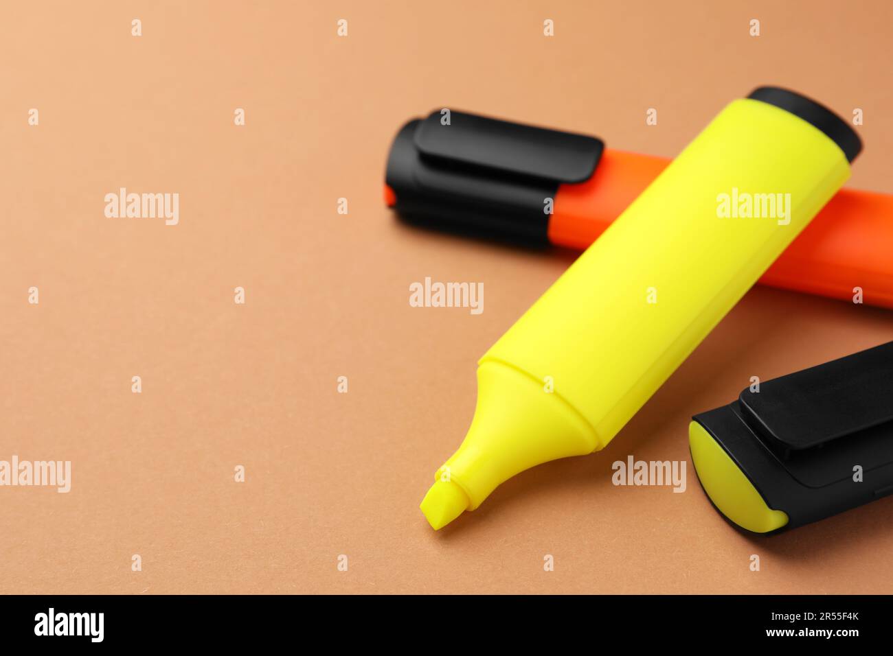 Bright color markers on pale orange background, closeup. Space for text ...