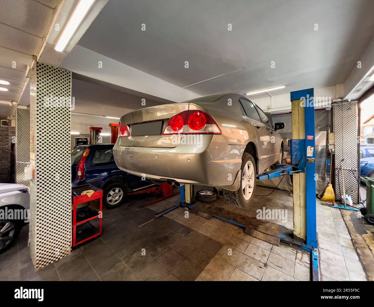 Car on lift, rear view. Car repair shop concept: Automobile service ...