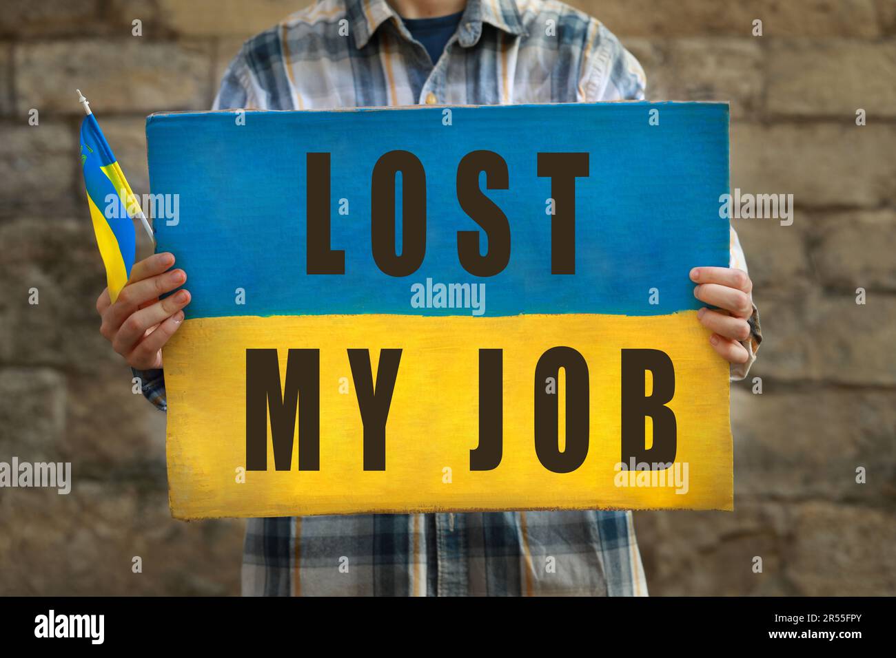 Unemployed due to war. Woman holding poster in colors of Ukrainian flag ...