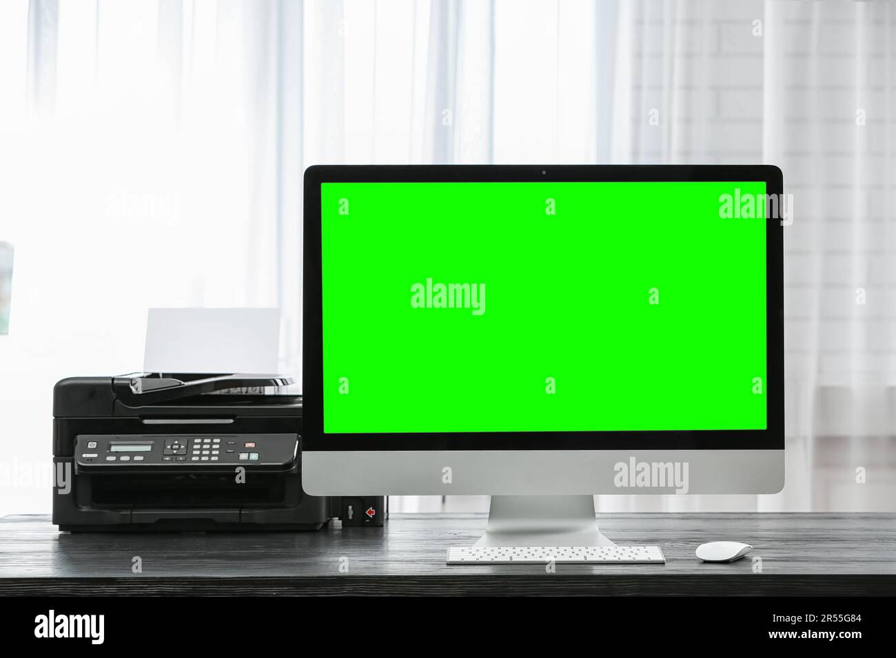 Computer display with chroma key on desk in room. Comfortable workplace ...