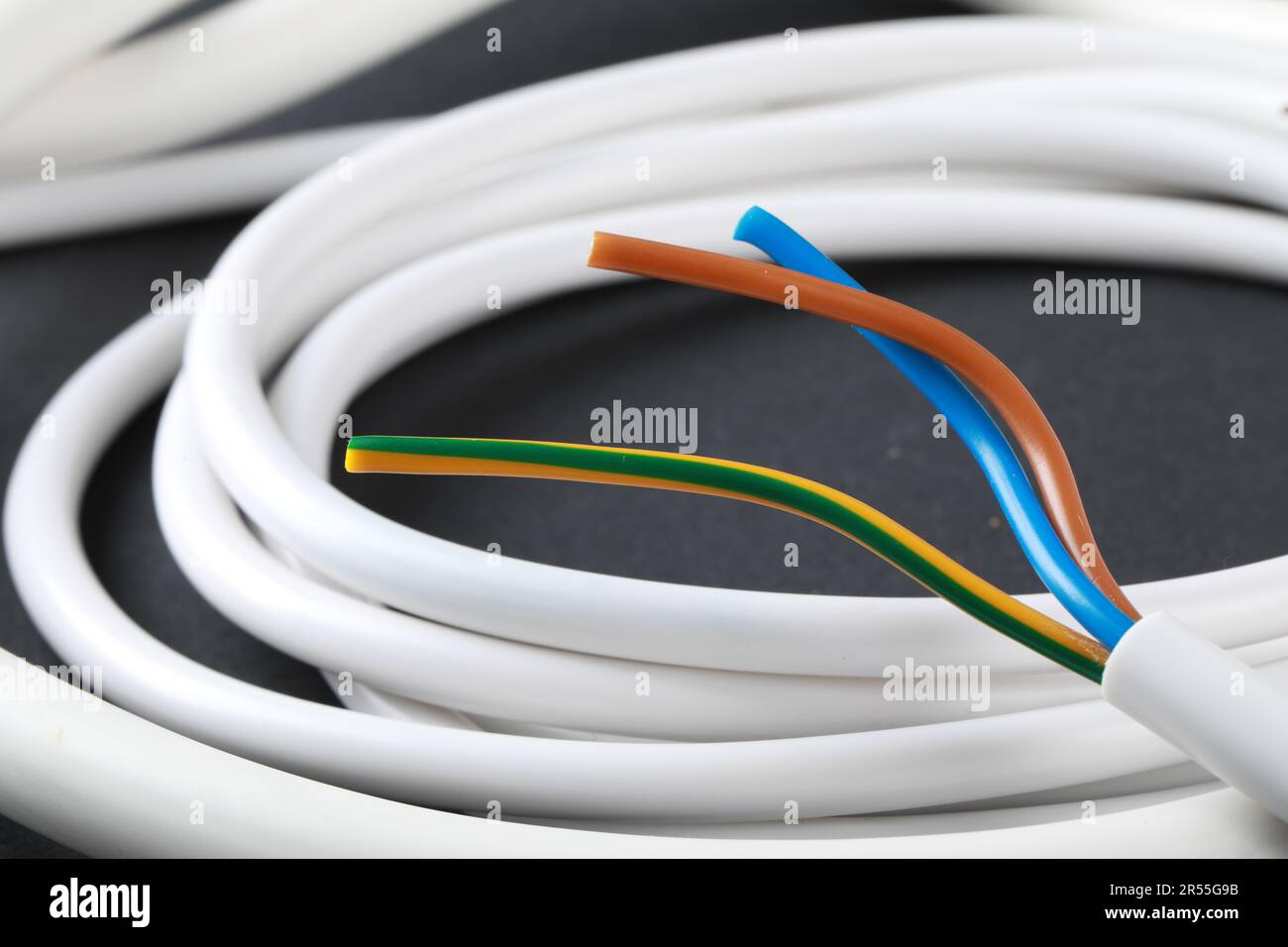 One new electrical wire on gray background Stock Photo - Alamy