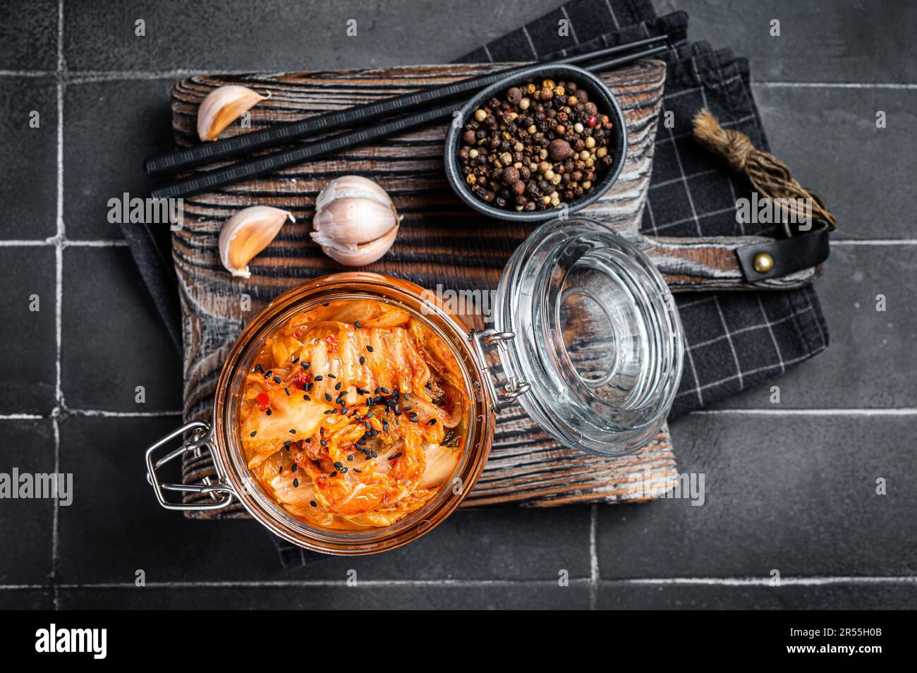 Homemade kimchi in a glass jar, traditional Korean cuisine. Black ...